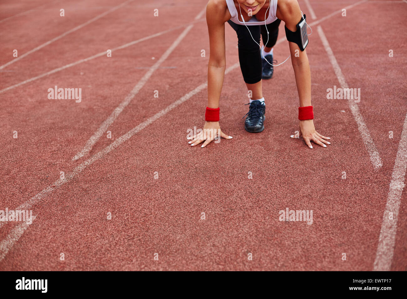 Young female runner ready to start Stock Photo - Alamy