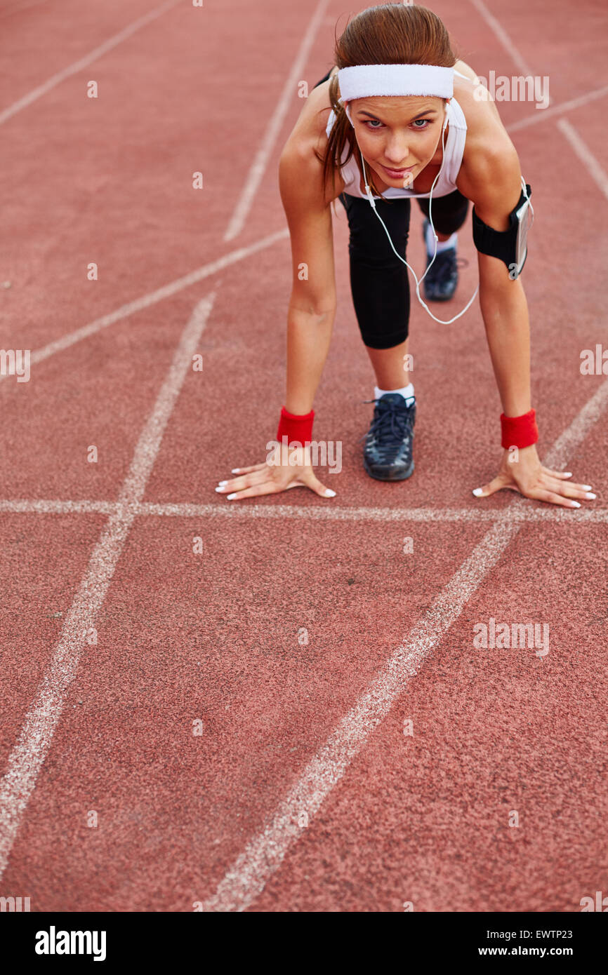 Fit girl standing at start line Stock Photo - Alamy