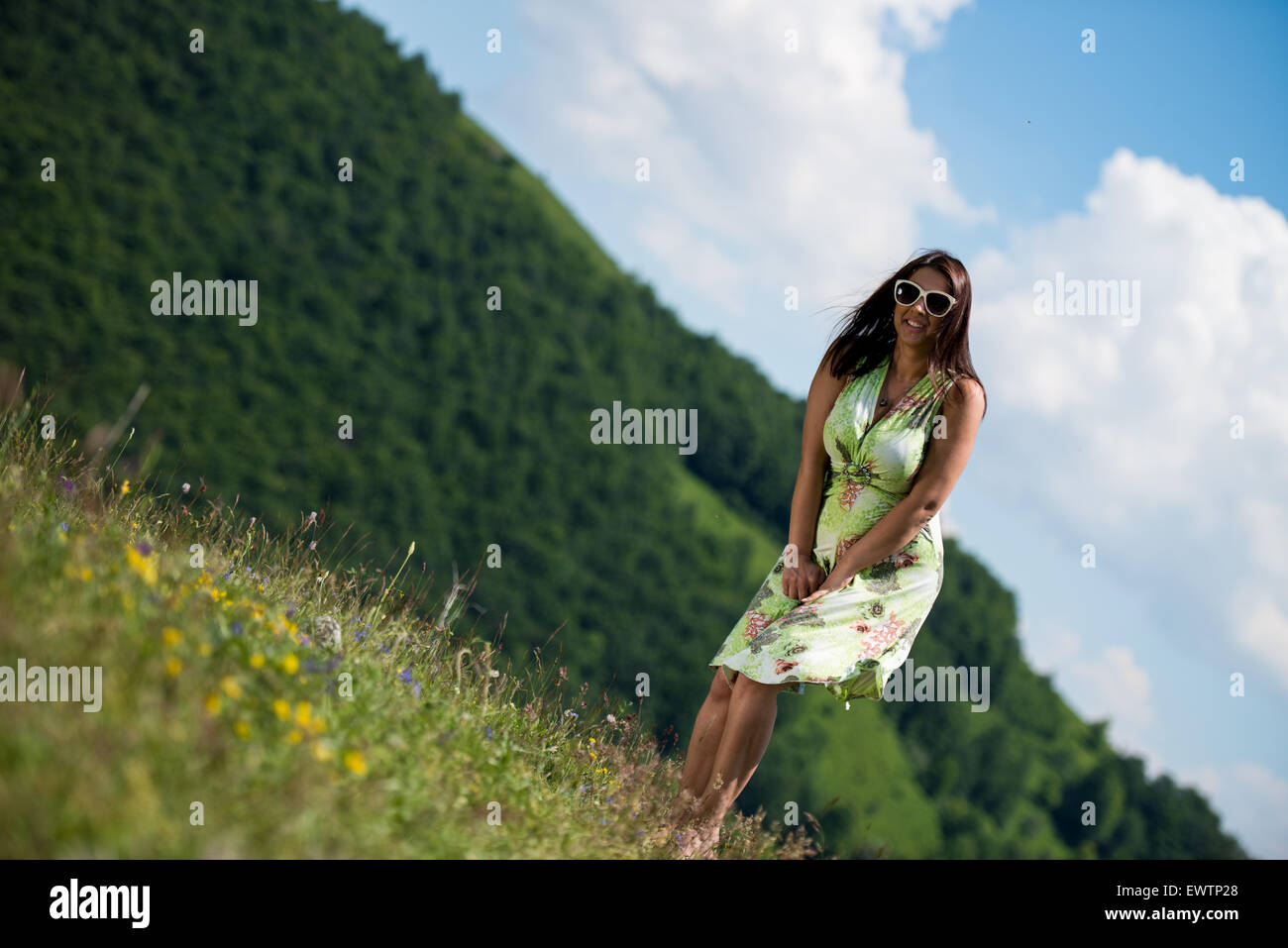 young woman in dress standing on the grass Stock Photo - Alamy