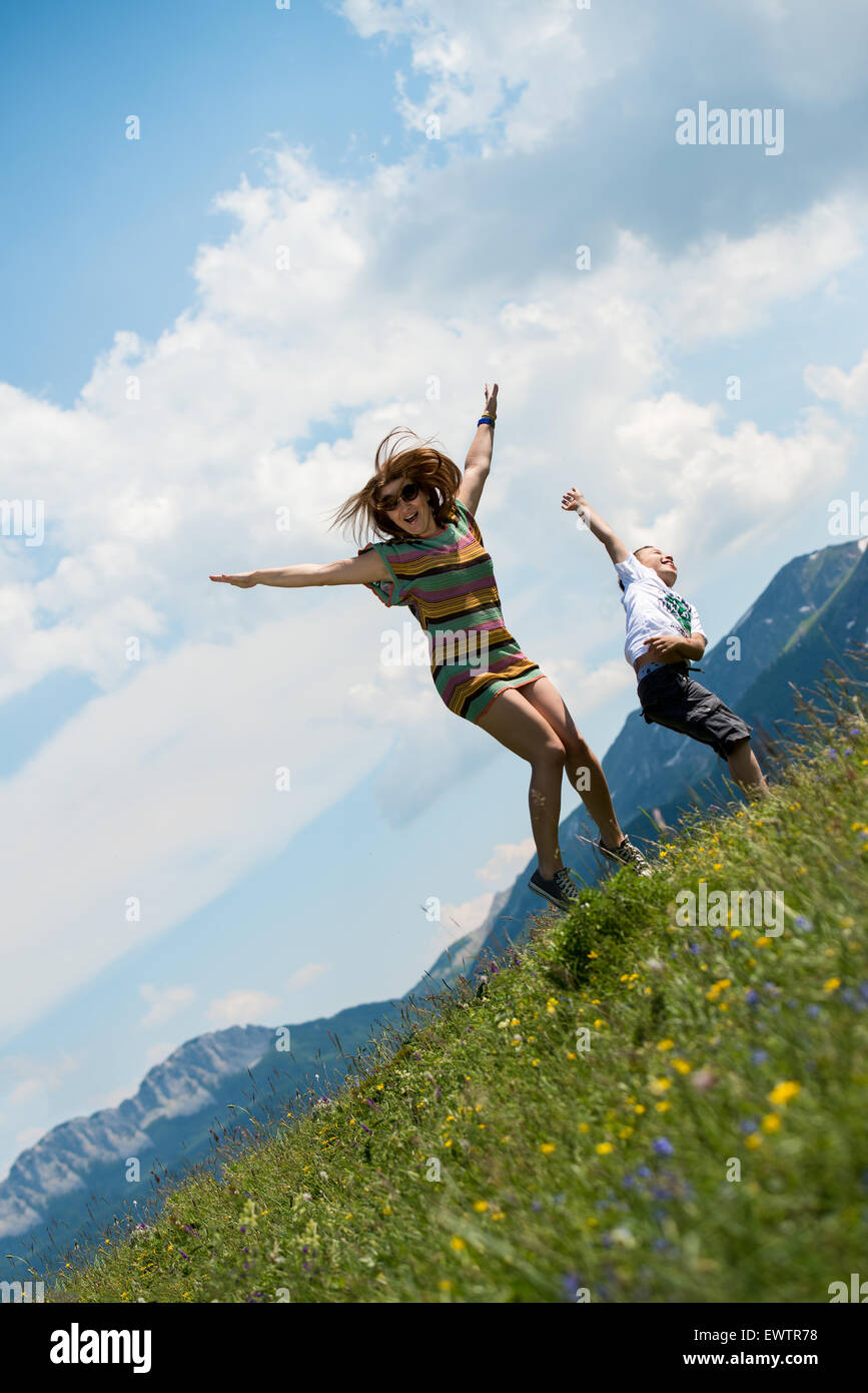 mother and son jumping in meadow Stock Photo - Alamy
