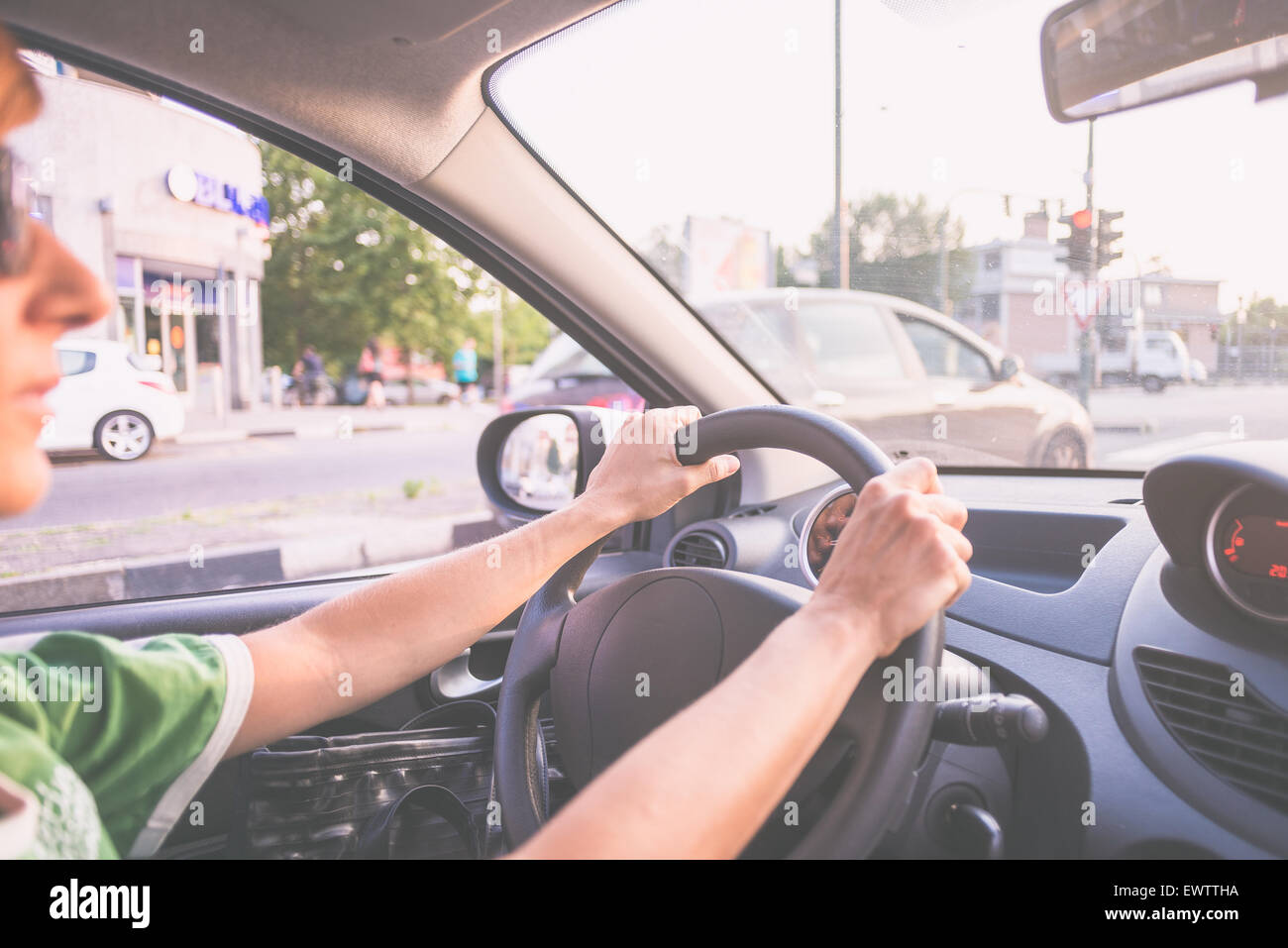 Adult woman driving car with hands on steering wheel. Interior close up ...
