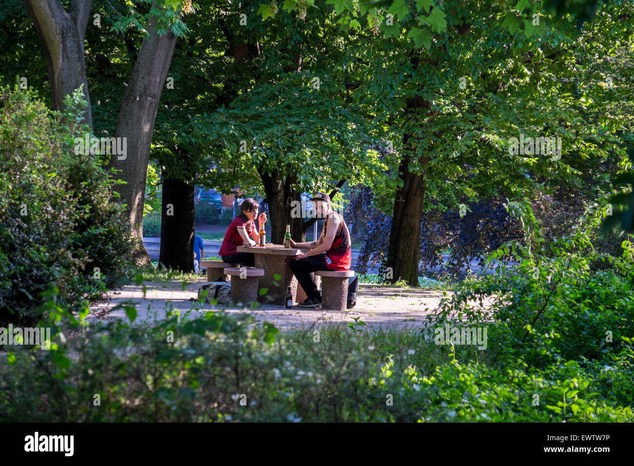 Couple relaxing at shady table in Berlin Public Park Volkspark am ...