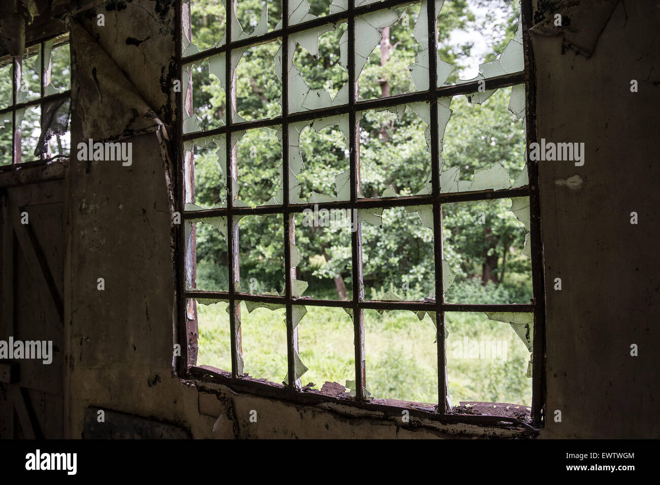 Broken windows on a derelict building Stock Photo - Alamy