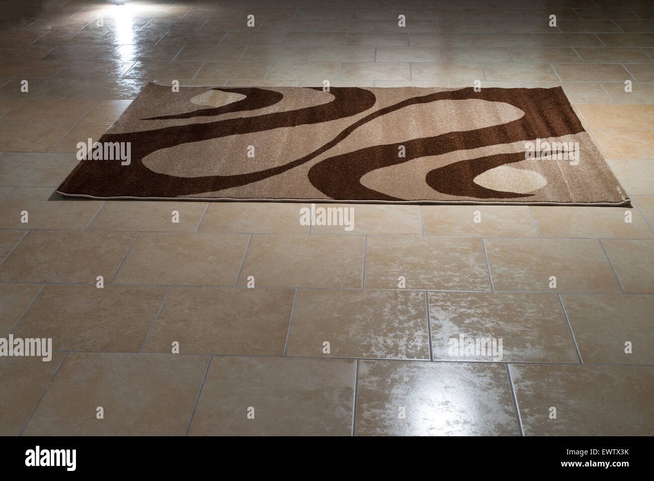 Single Brown Carpet Folded On Floor Stock Photo - Alamy