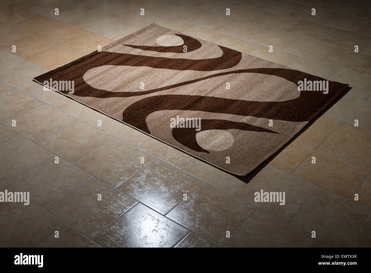 Single Brown Carpet Folded On Floor Stock Photo - Alamy