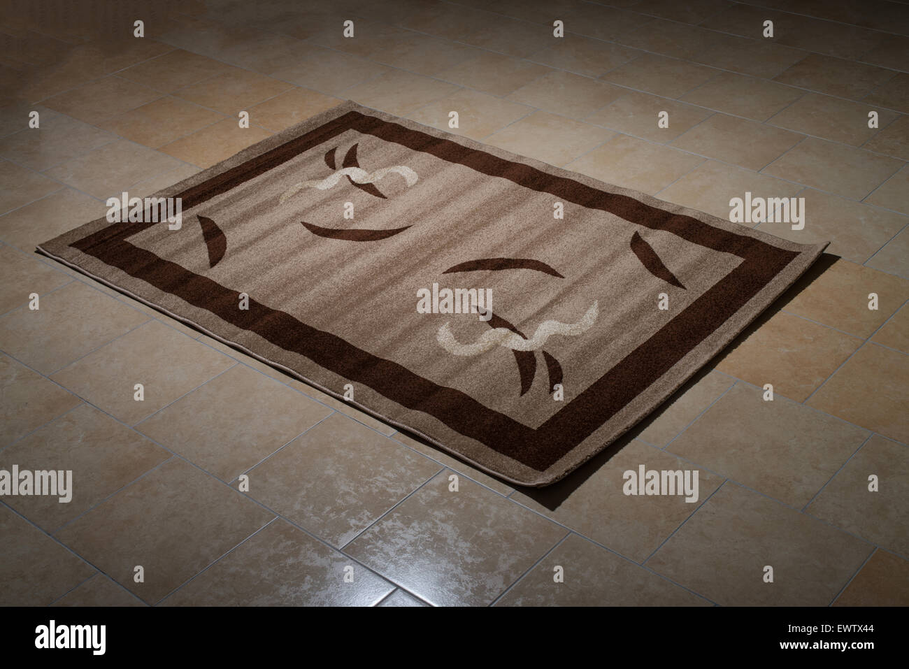 Single Brown Carpet Folded On Floor Stock Photo - Alamy