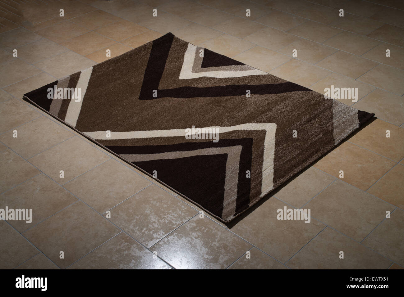 Single Brown Carpet Folded On Floor Stock Photo - Alamy