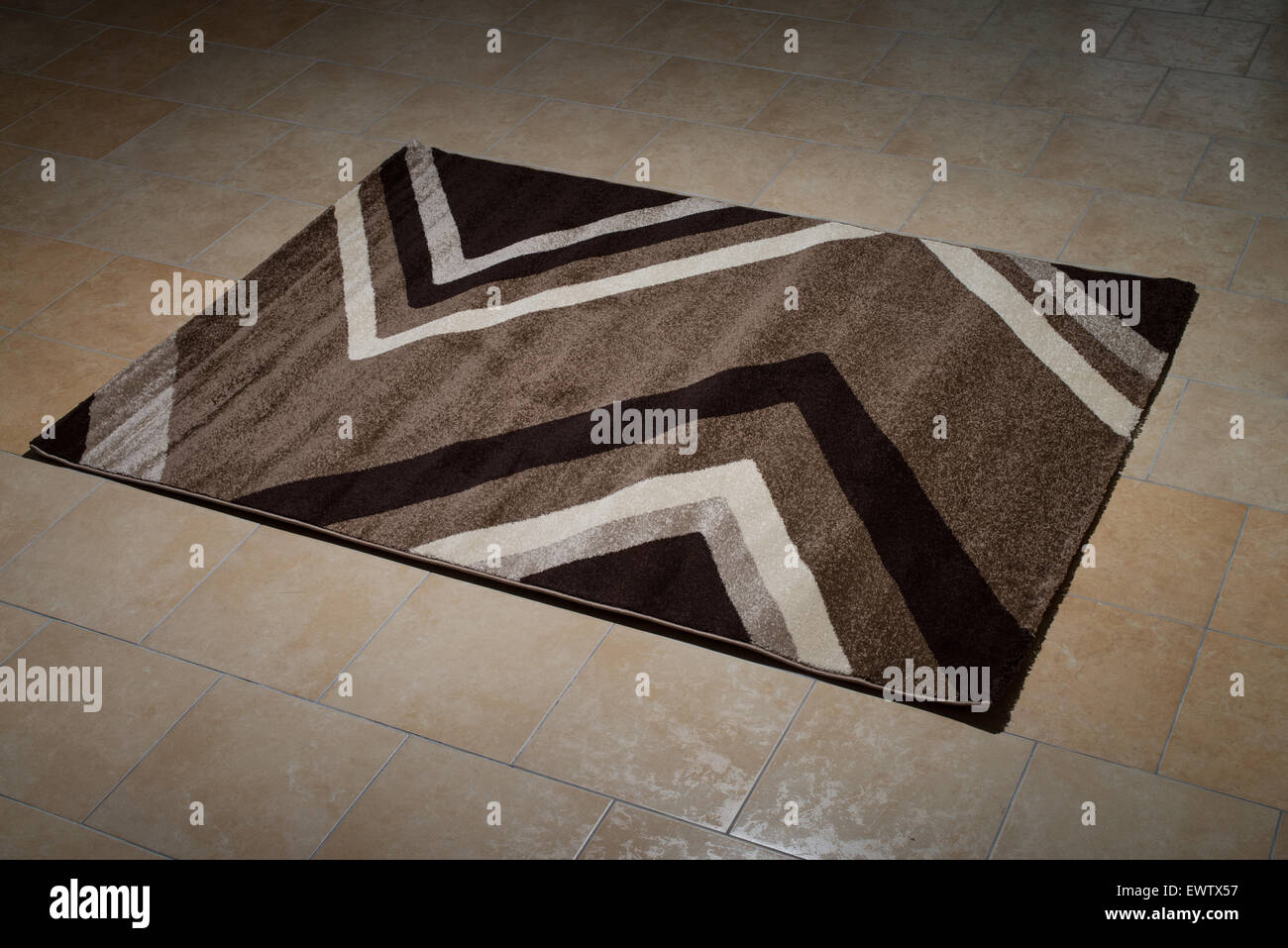 Single Brown Carpet Folded On Floor Stock Photo - Alamy