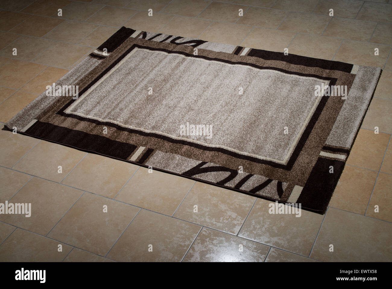 Single Brown Carpet Folded On Floor Stock Photo - Alamy