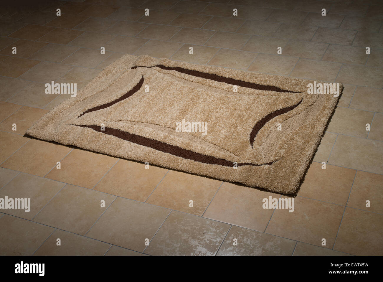 Single Brown Carpet Folded On Floor Stock Photo - Alamy