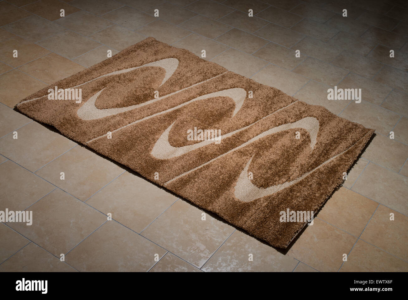 Single Brown Carpet Folded On Floor Stock Photo - Alamy