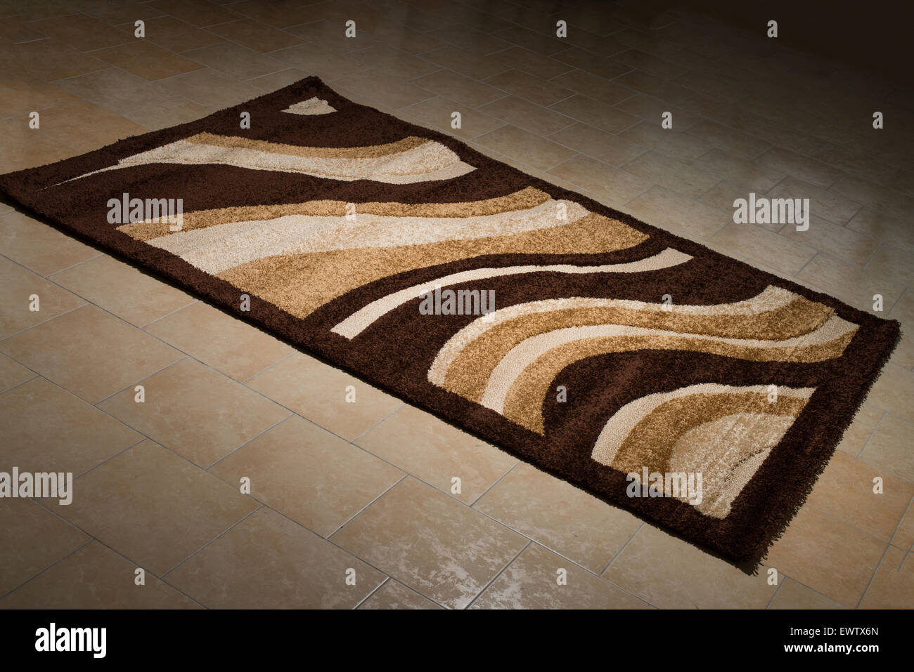 Single Brown Carpet Folded On Floor Stock Photo - Alamy
