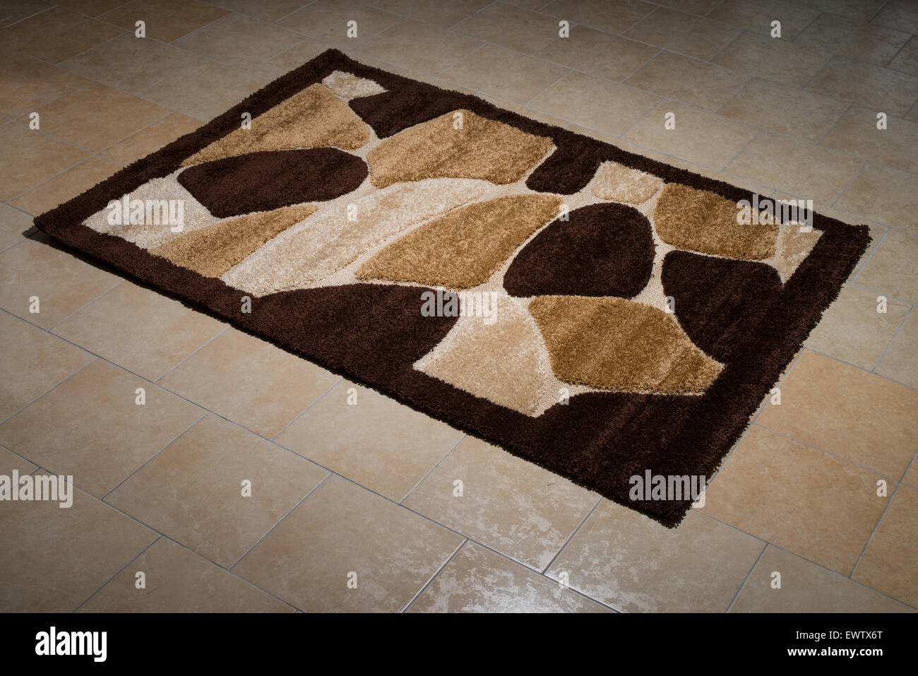 Single Brown Carpet Folded On Floor Stock Photo - Alamy