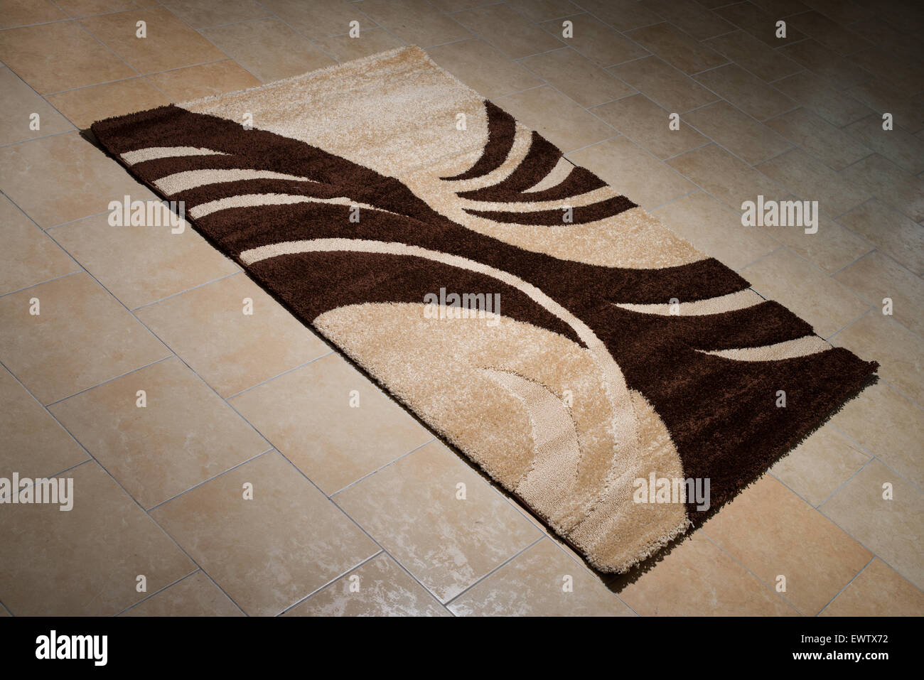 Single Brown Carpet Folded On Floor Stock Photo - Alamy