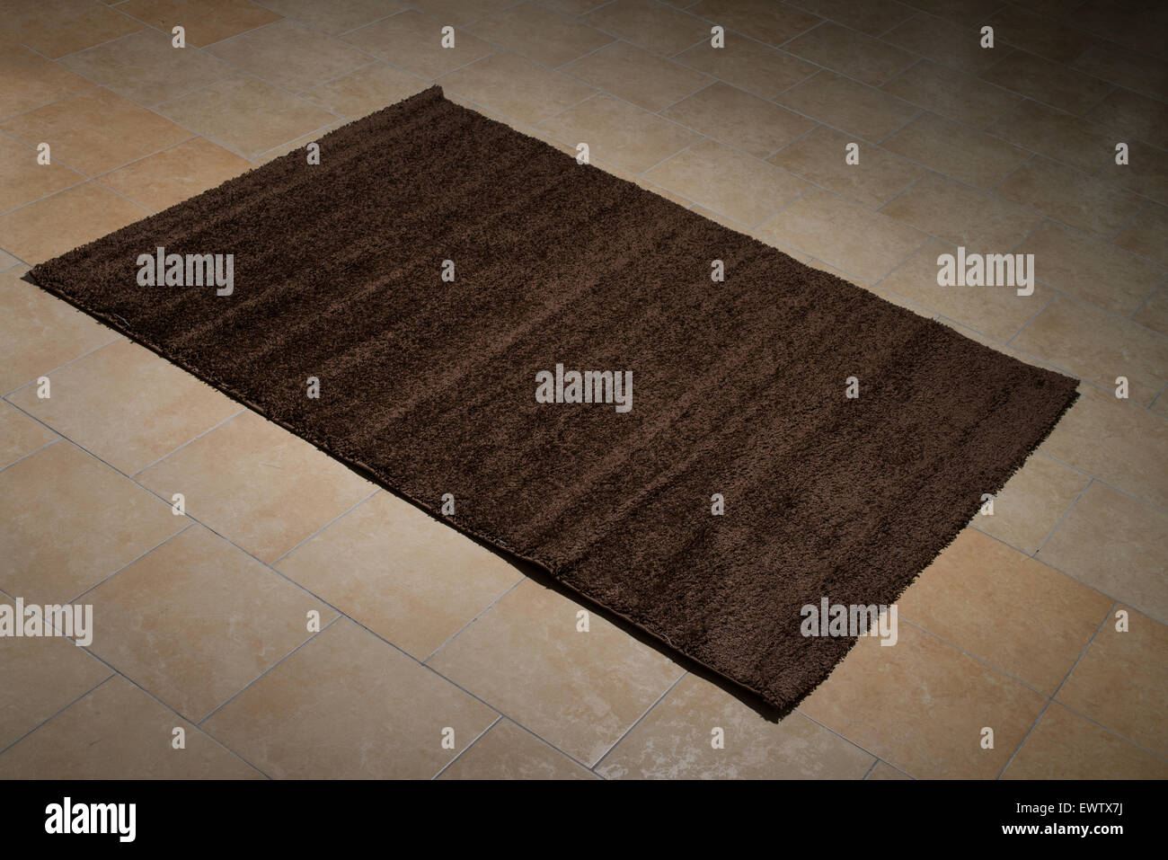 Single Brown Carpet Folded On Floor Stock Photo - Alamy