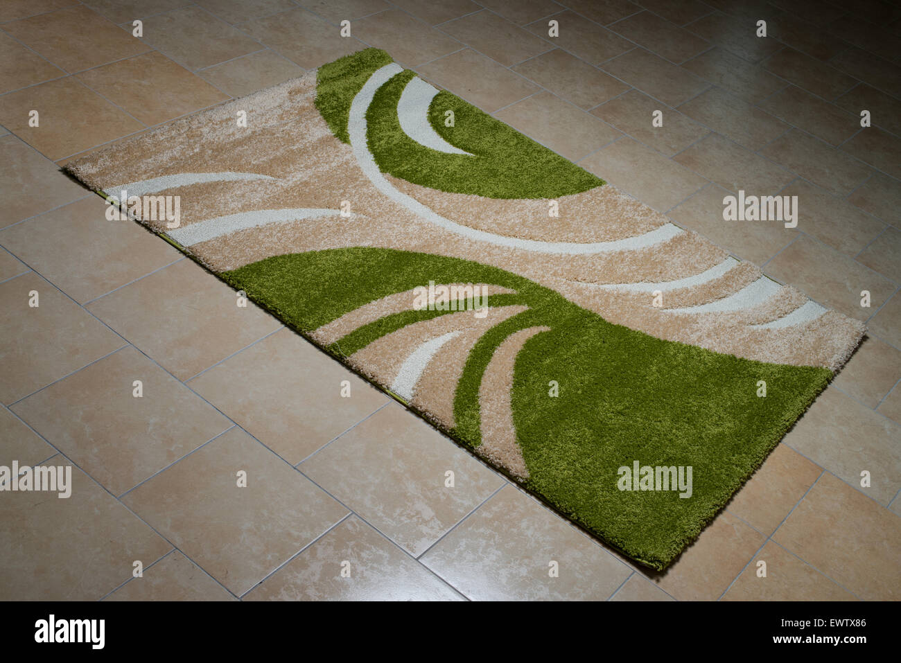 Single Green Carpet Folded On Floor Stock Photo - Alamy