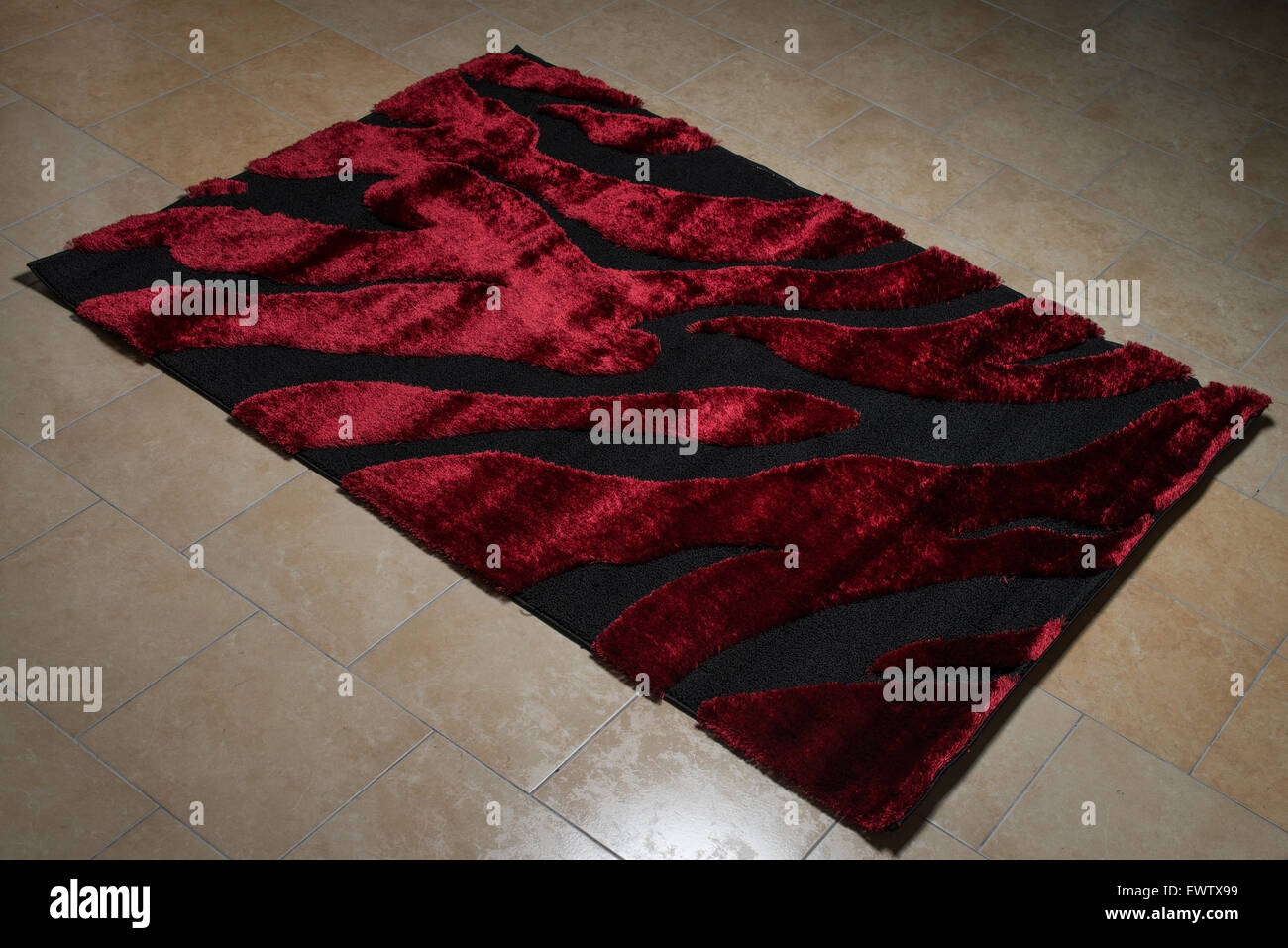 Single Red Carpet Folded On Floor Stock Photo - Alamy