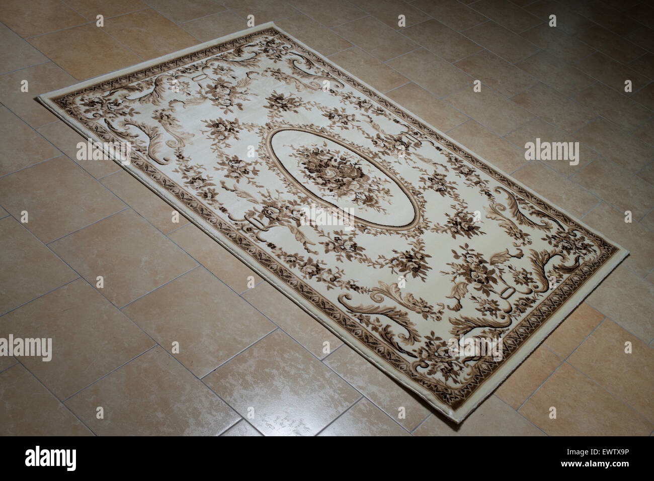 Persian Rug Isolated On Tiles Stock Photo - Alamy