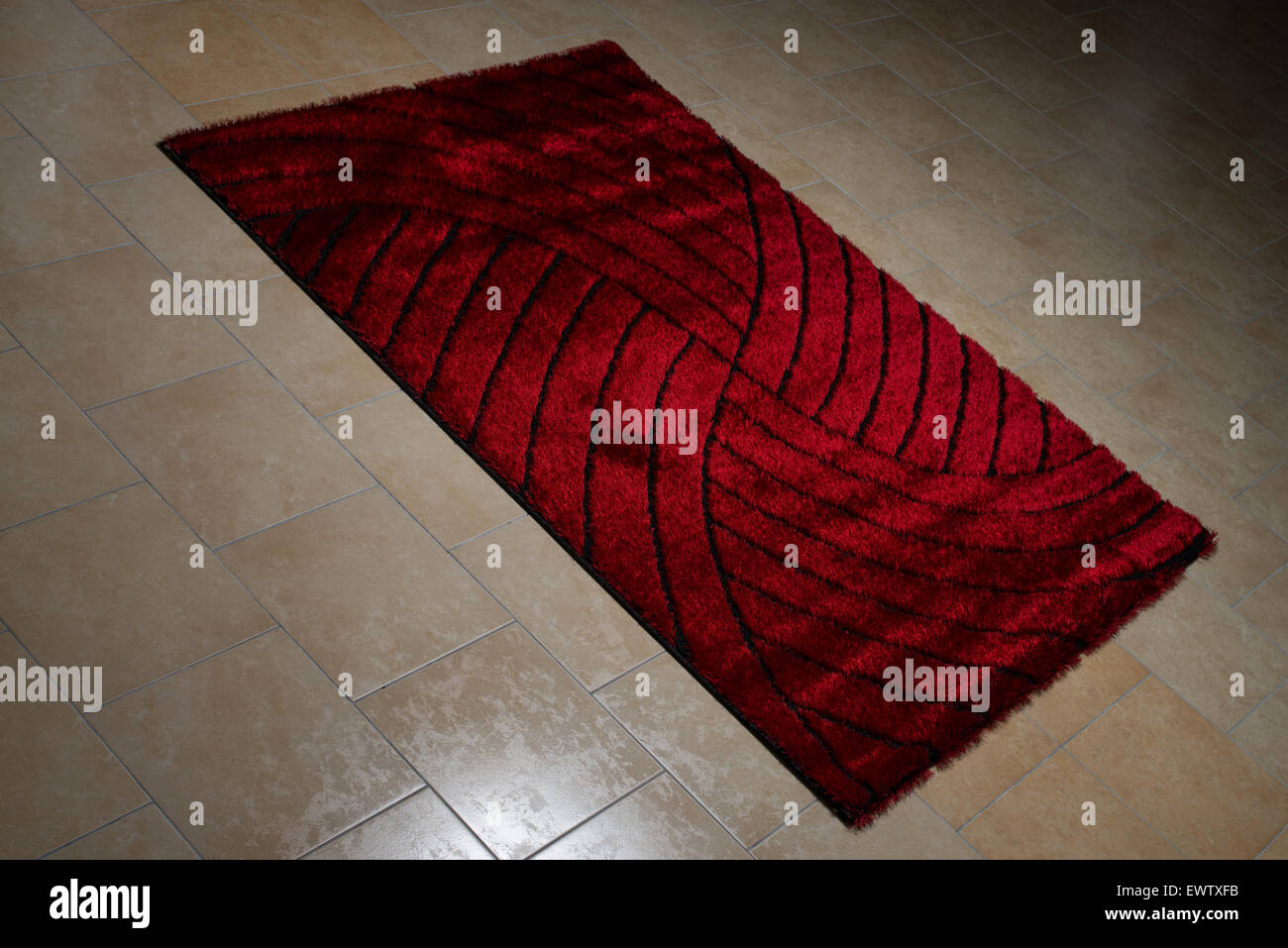 Single Red Carpet Folded On Floor Stock Photo - Alamy