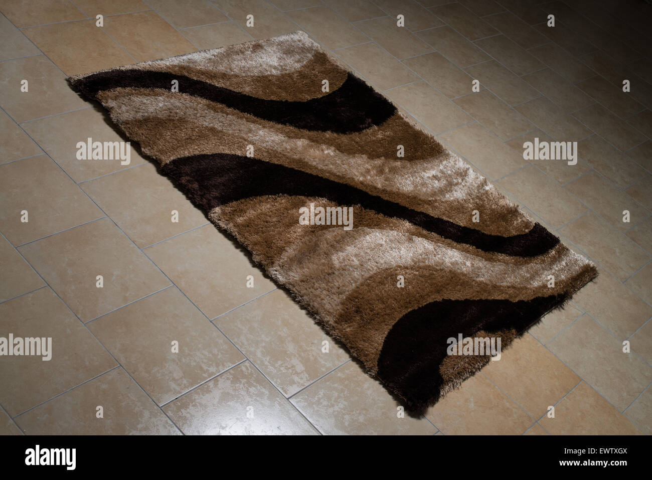 Single Brown Carpet Folded On Floor Stock Photo - Alamy