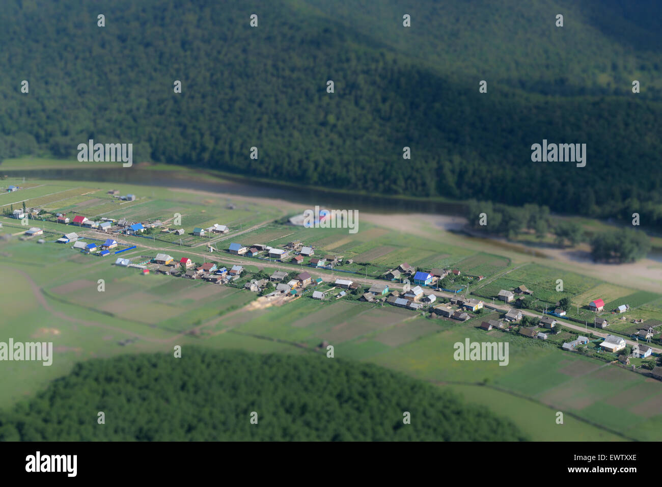 Small isolated village surrounded by forests from an Ariel position ...