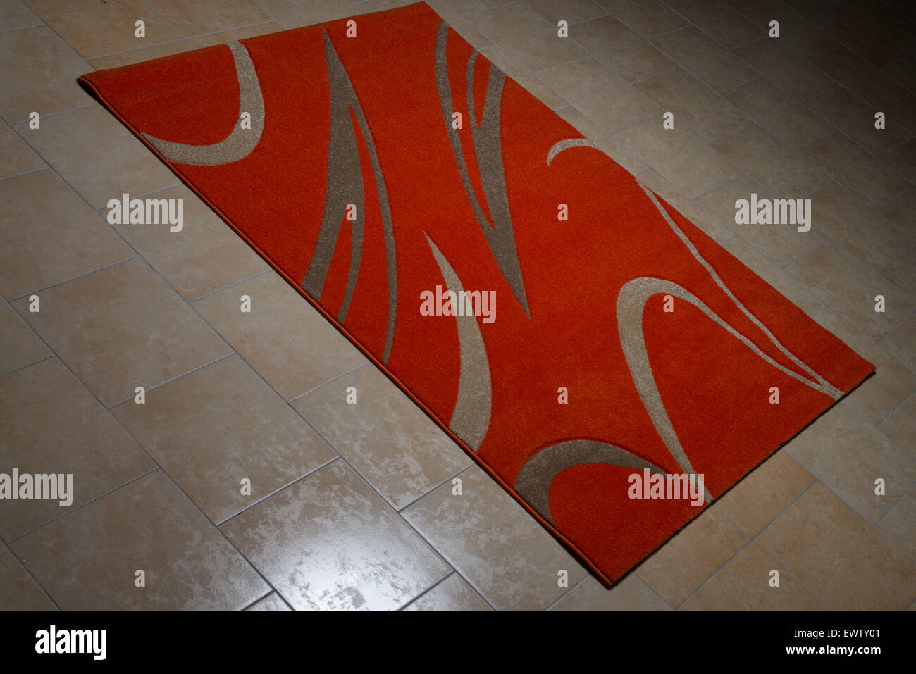 Single Red Carpet Folded On Floor Stock Photo - Alamy