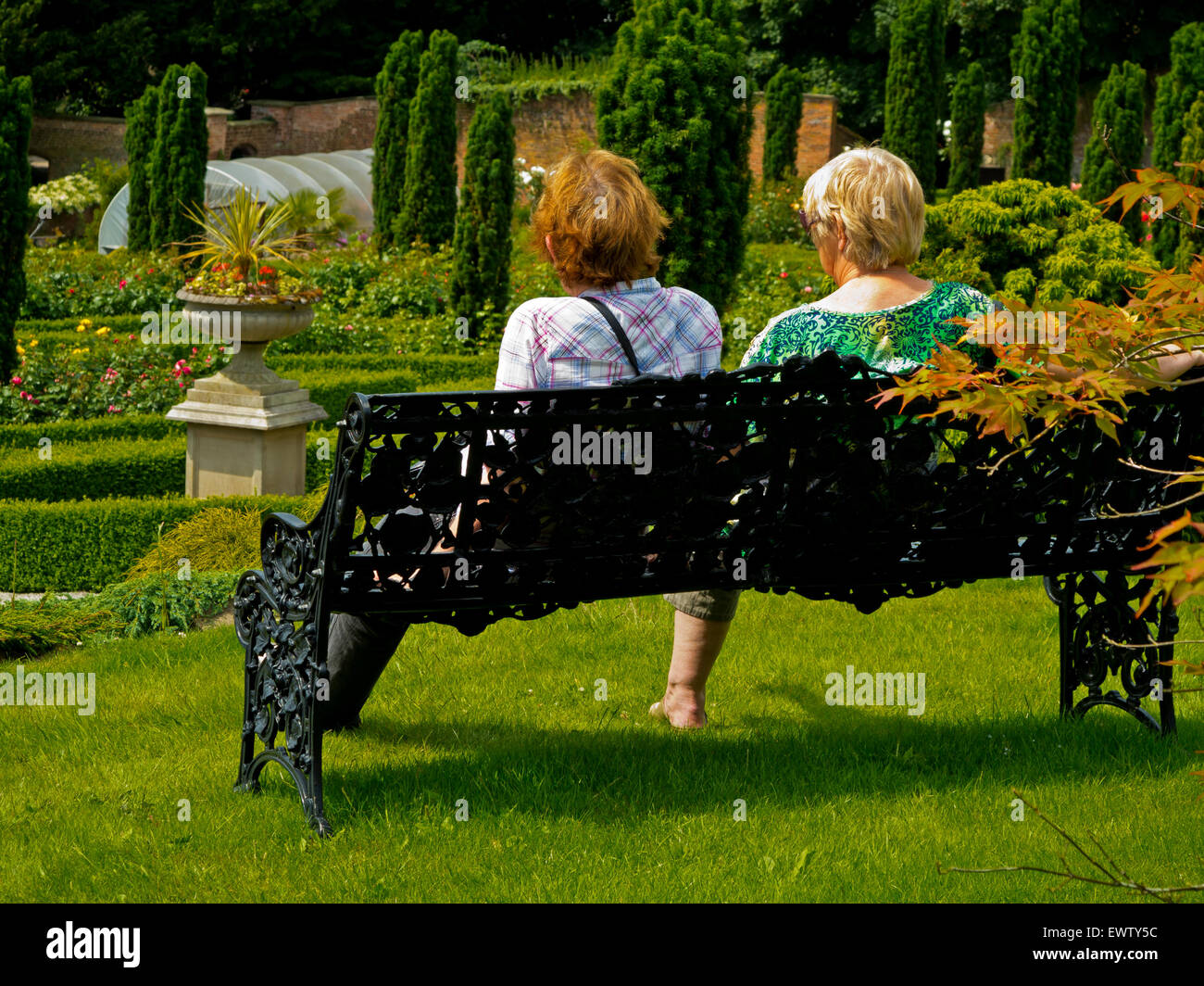 Visitors enjoying the rose garden in summer at Hopton Hall in the ...