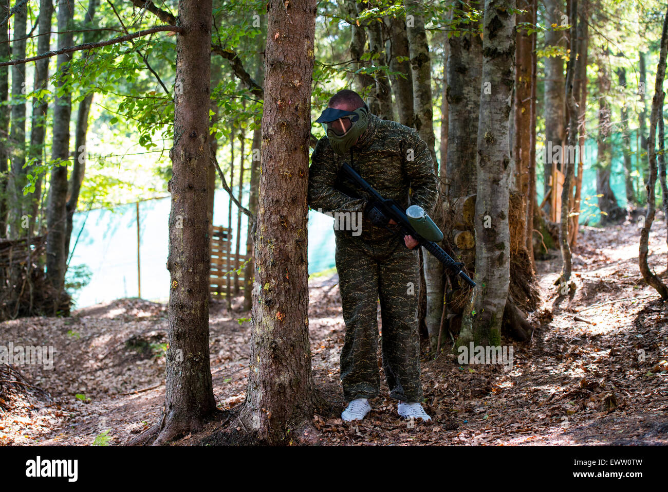 Paintball player Hiding Stock Photo - Alamy
