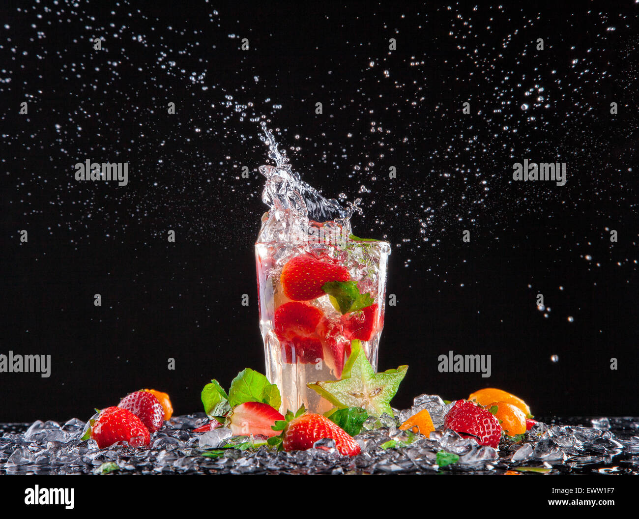 Exotic drink with splash, isolated on black background Stock Photo - Alamy