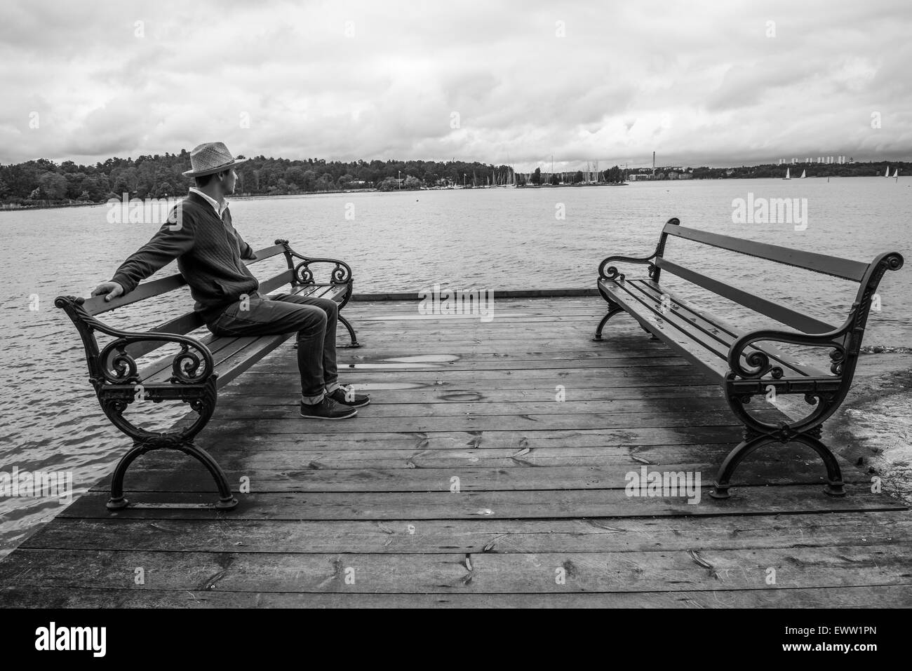 Man sitting on bench at sunset Black and White Stock Photos & Images ...
