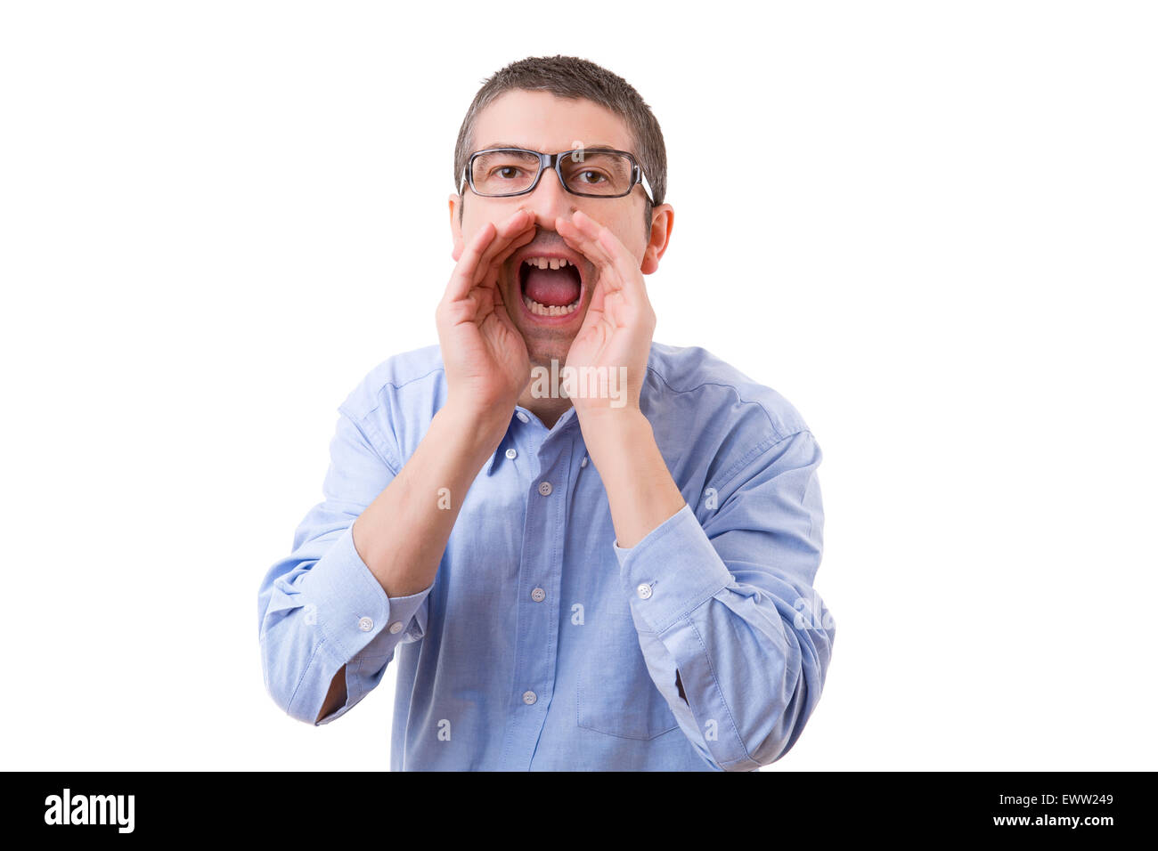Young business man screaming at you, isolated over white background ...