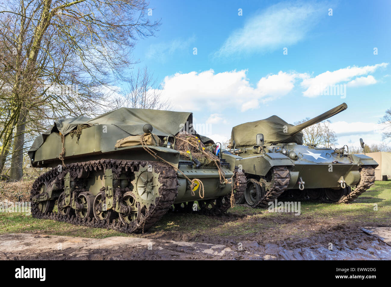 Two military tanks parked for exhibition in nature with blue sky and ...