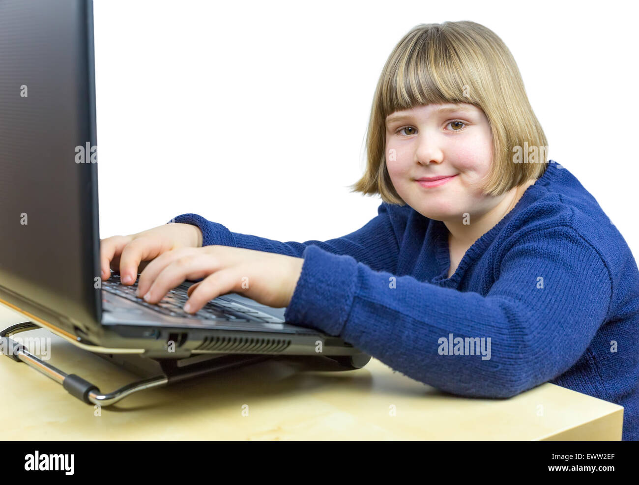 Young smiling caucasian girl working on laptop computer isolated on ...