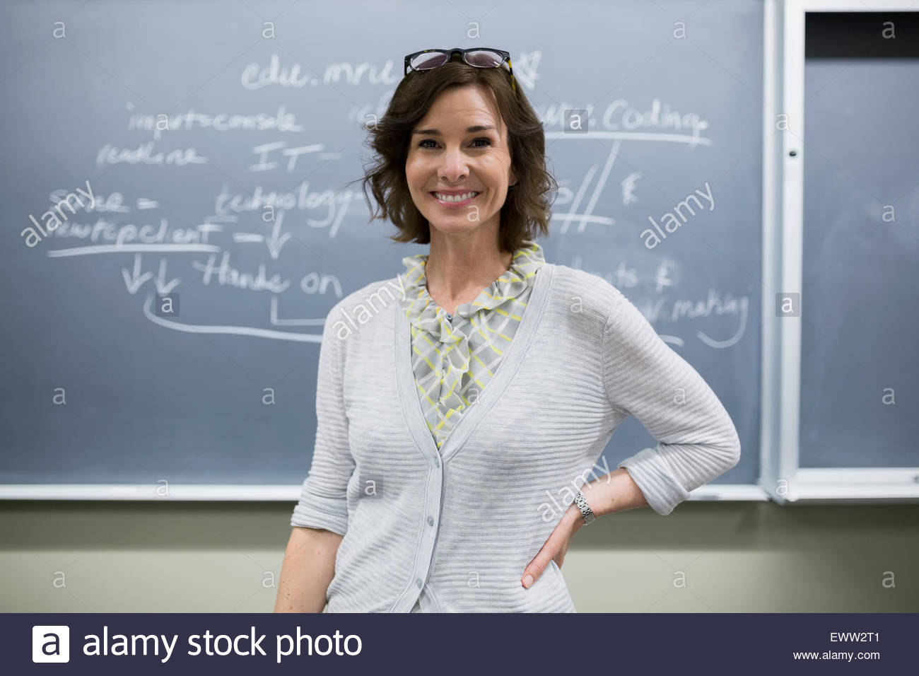 Portrait smiling professor at blackboard in classroom Stock Photo - Alamy