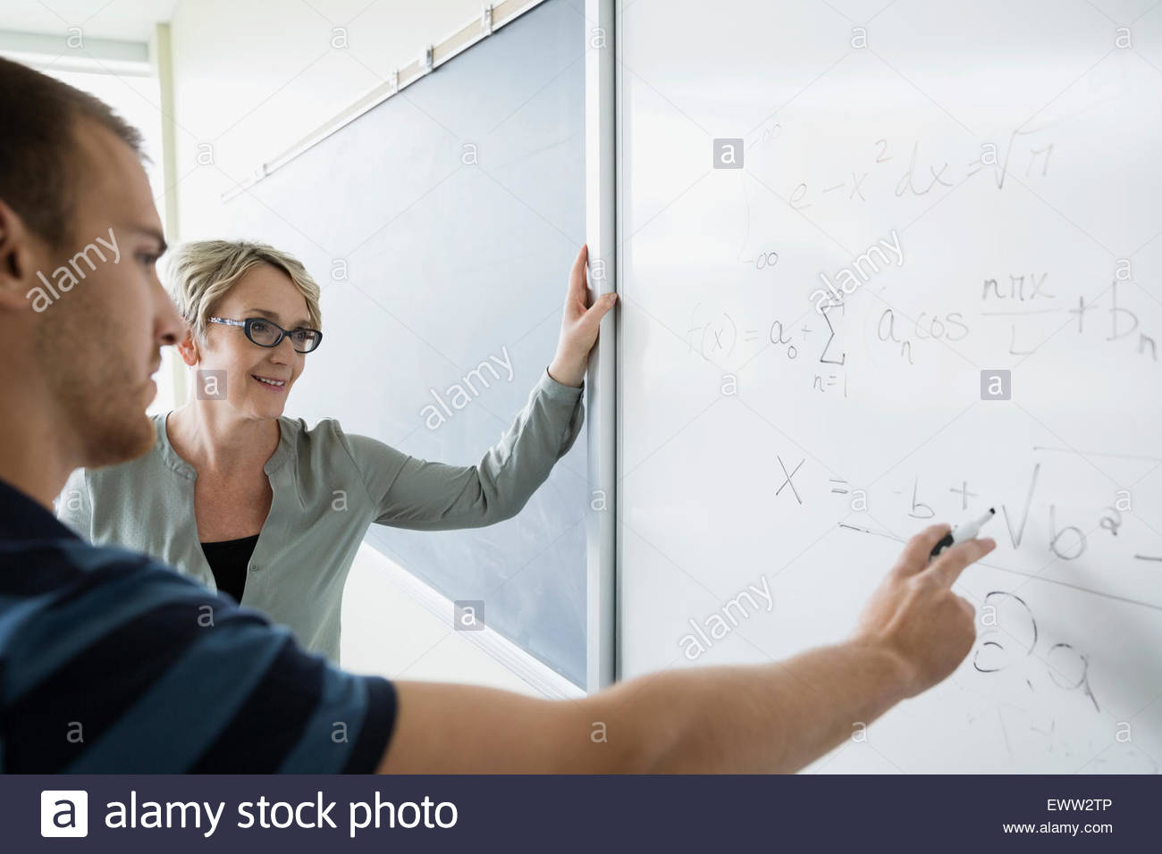 Trigonometry professor and college student solving equation whiteboard ...