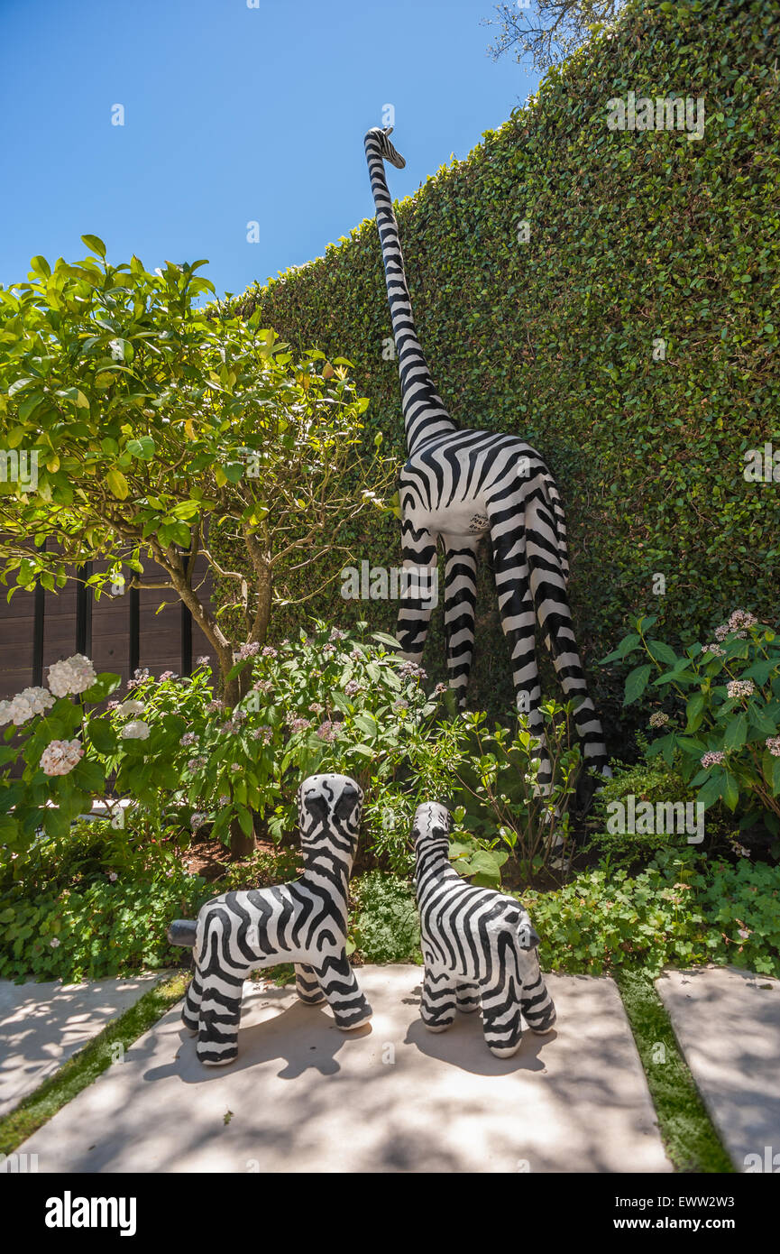 Large and small yard art giraffes in backyard garden Stock Photo - Alamy