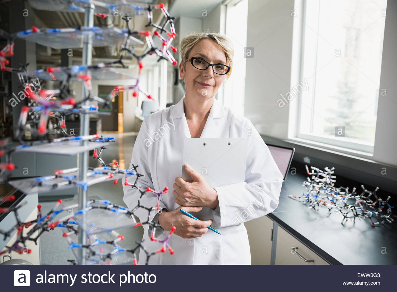 Portrait confident scientist behind molecule model in laboratory Stock ...