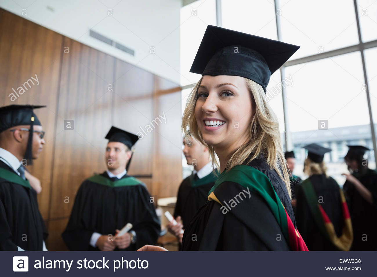 Portrait of young man in graduating cap and gown hi-res stock ...