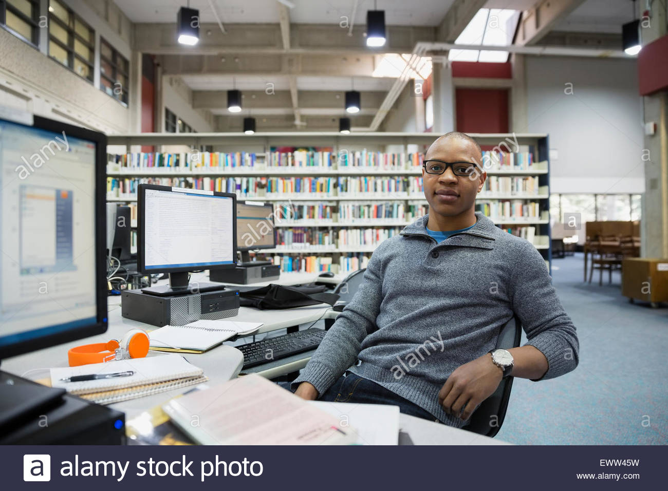 Portrait college student studying at computer in library Stock Photo ...