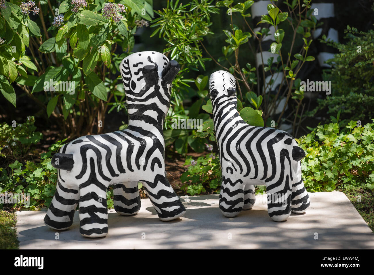 Two black and white striped yard art giraffe figurines Stock Photo - Alamy