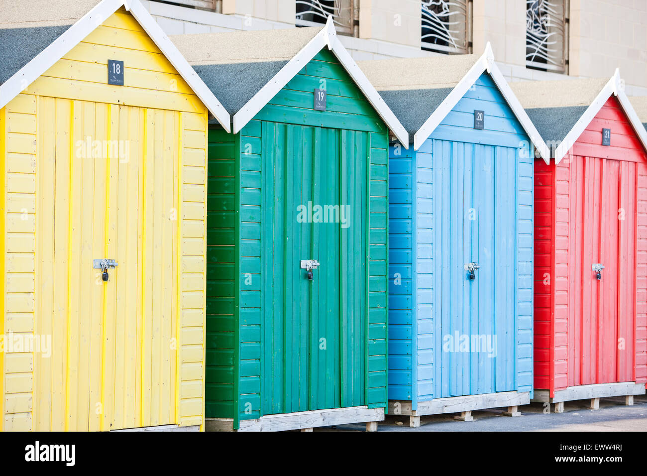 sunny Spring day colourful beach huts next to Boscombe Pier in Boscombe ...