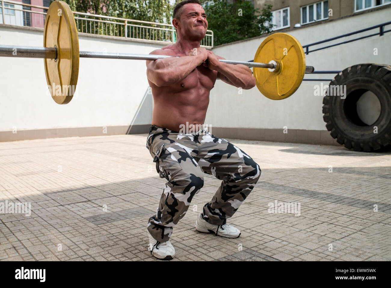 Bodybuilder Doing Front Squats With Barbells Stock Photo - Alamy