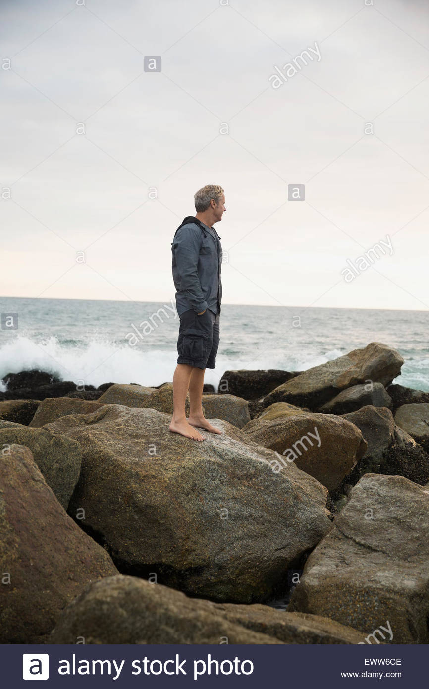 Man standing on the rocks hi-res stock photography and images - Alamy
