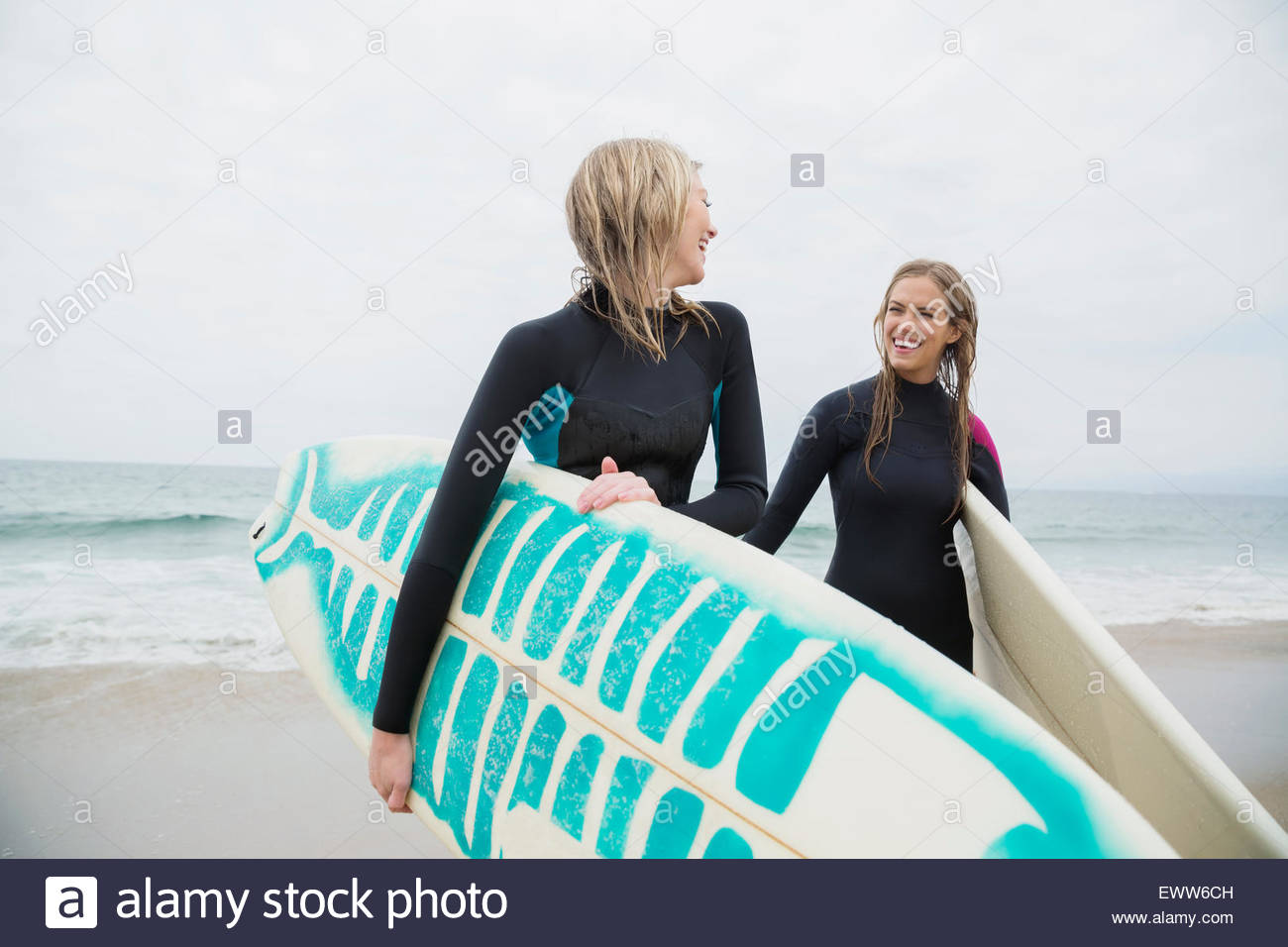 Two young women holding surfboards hi-res stock photography and images ...