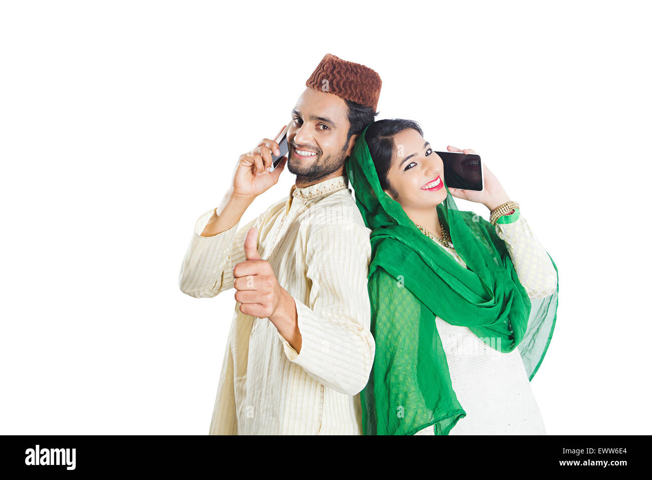 2 indian Muslim Married Couple talking Cell Phone and thumbs up showing ...