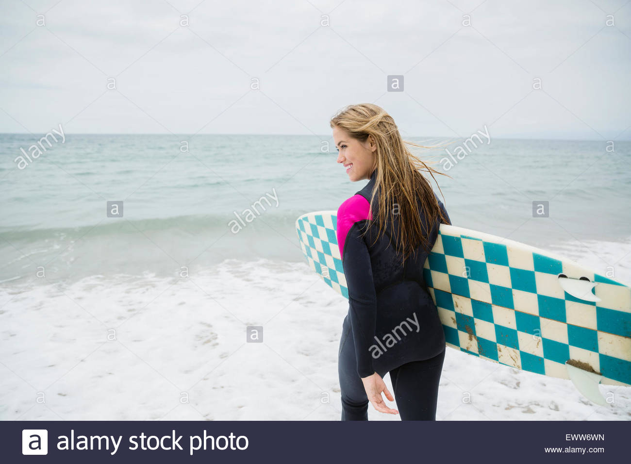 Young woman carrying surfboard hi-res stock photography and images - Alamy
