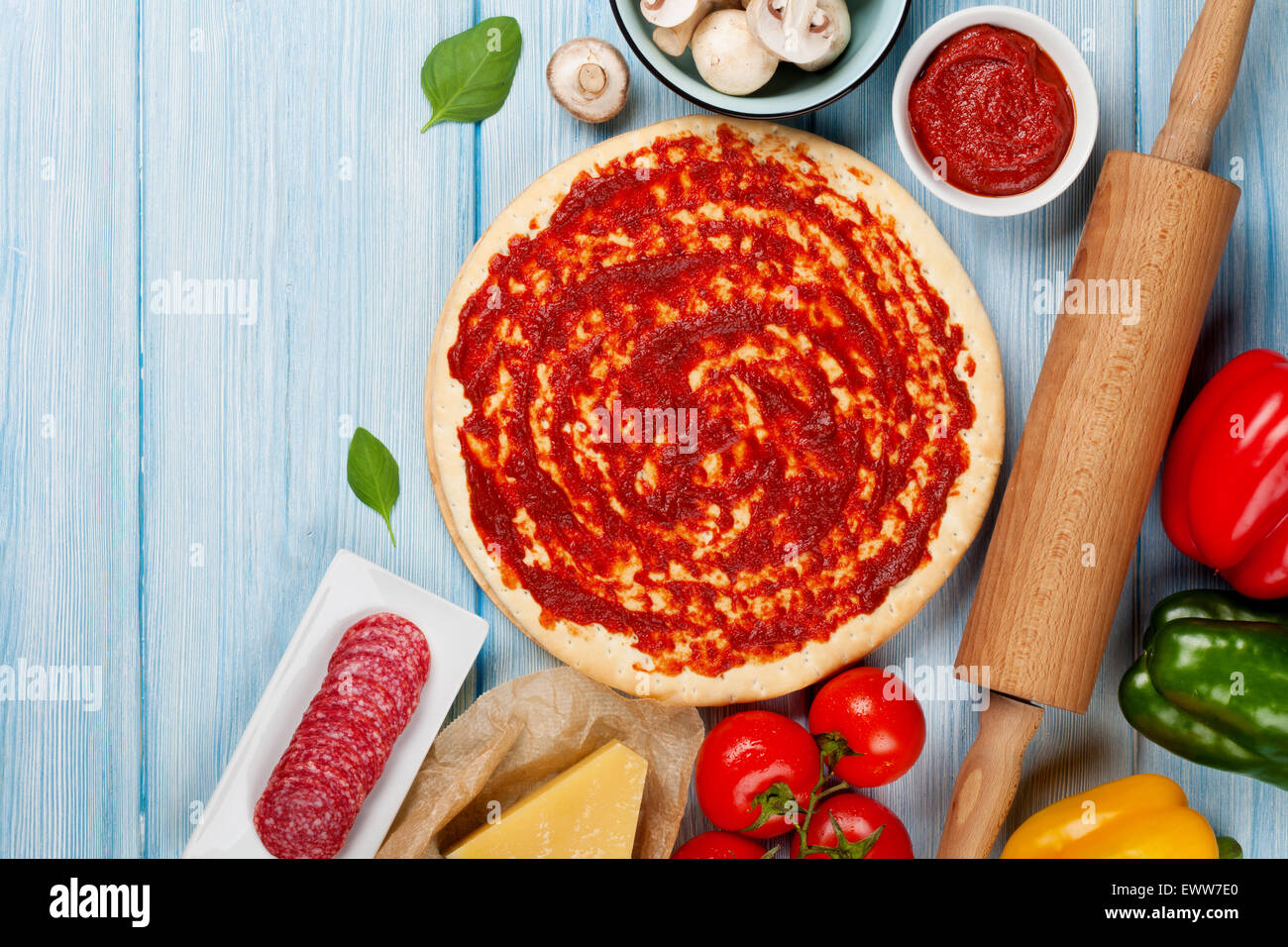 Pizza cooking ingredients. Dough, vegetables and spices. Top view with ...