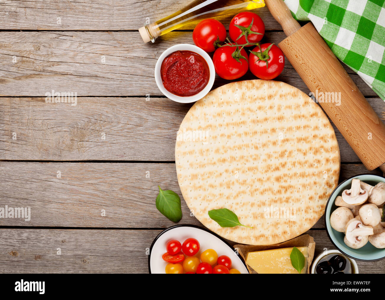 Pizza cooking ingredients. Dough, vegetables and spices. Top view with ...
