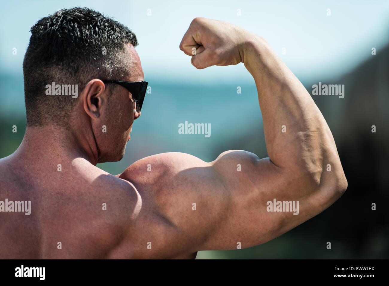 Man Athlete Showing Biceps Stock Photo - Alamy