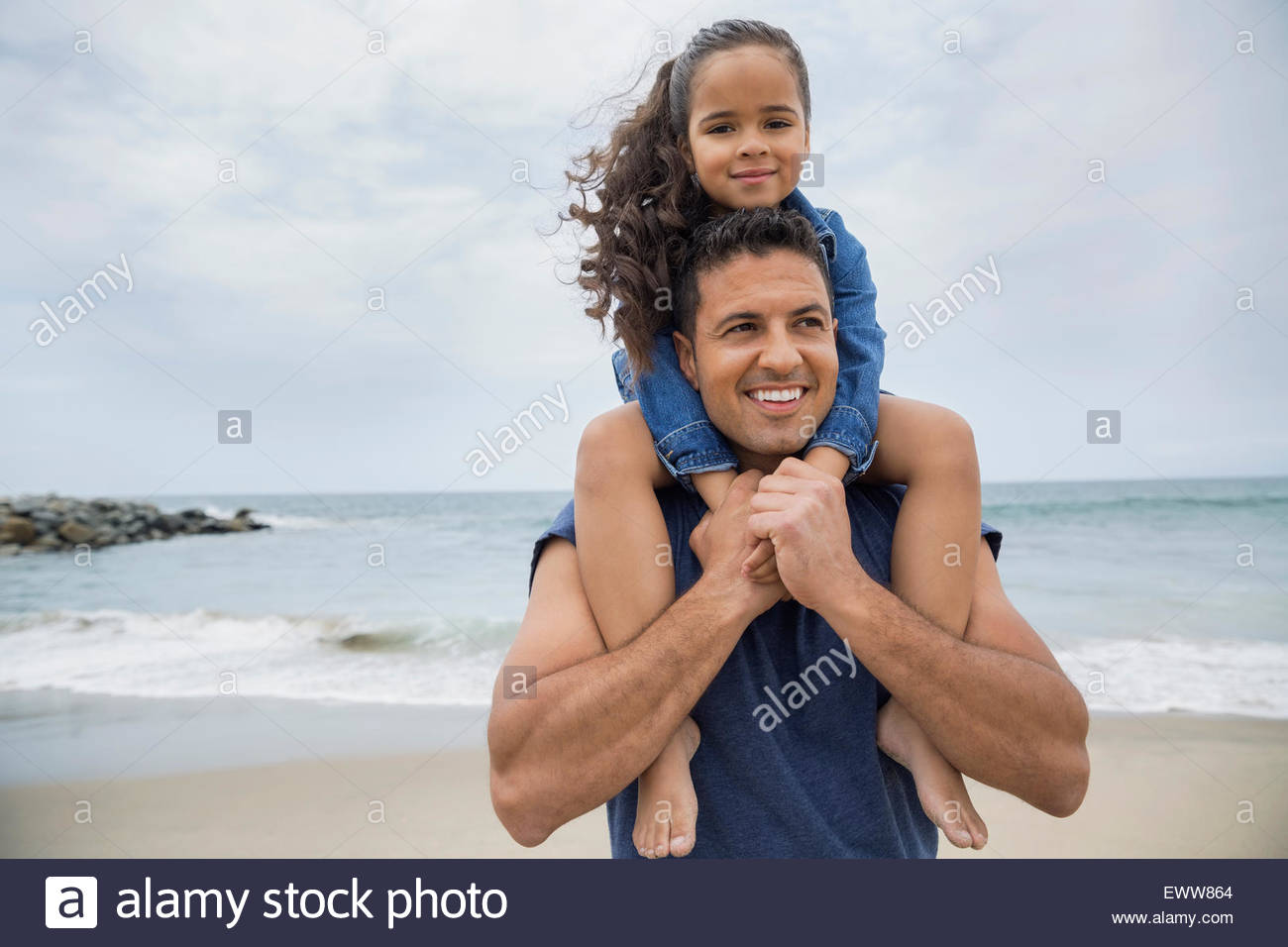 Father carrying daughter on the beach hi-res stock photography and images - Alamy